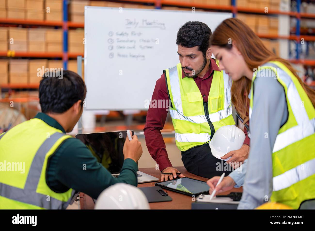 Group of worker in the warehouse factory conduct toolbox talk daily ...