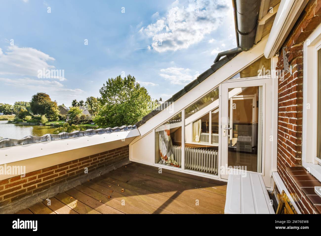 an outside area with wood flooring and white trim on the walls, windows ...