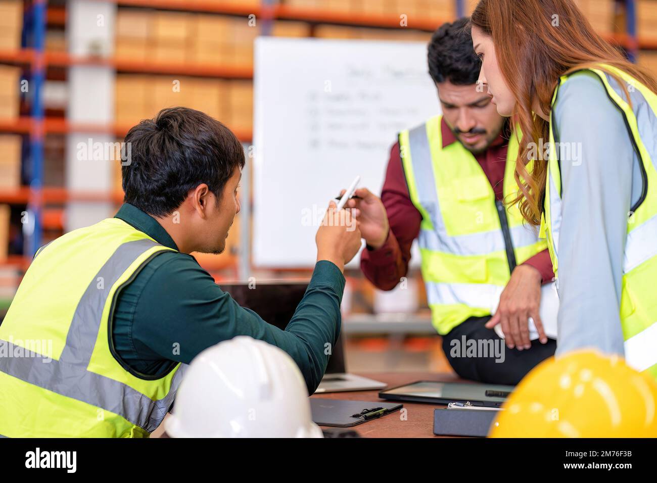 Group of worker in the warehouse factory conduct toolbox talk daily ...