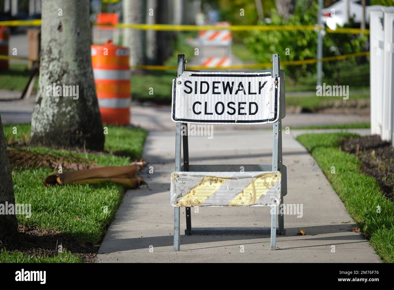Warning sign that sidewalk is closed at street construction site ...