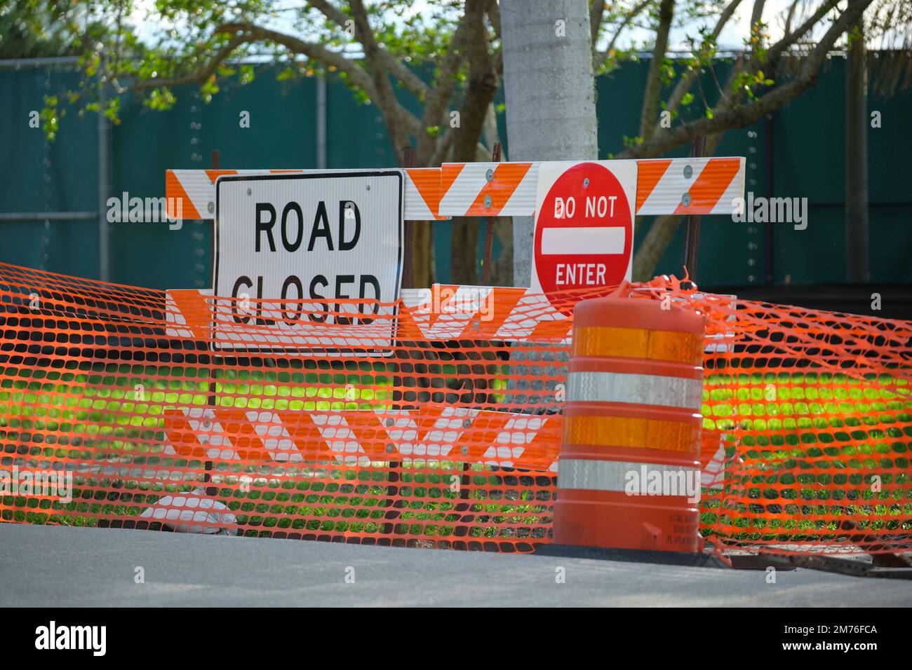 Yellow protective fence barrier at street construction site. Warning ...