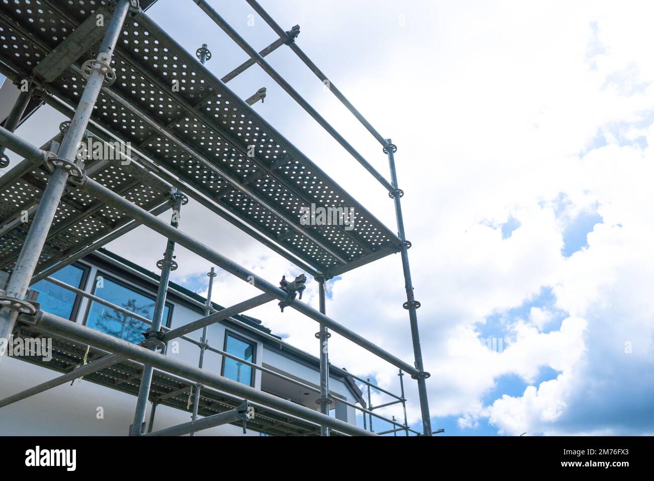 Modern house construction with scaffold pole platform. New build ...