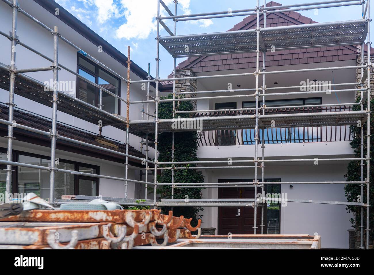 Modern house construction with scaffold pole platform. New build ...