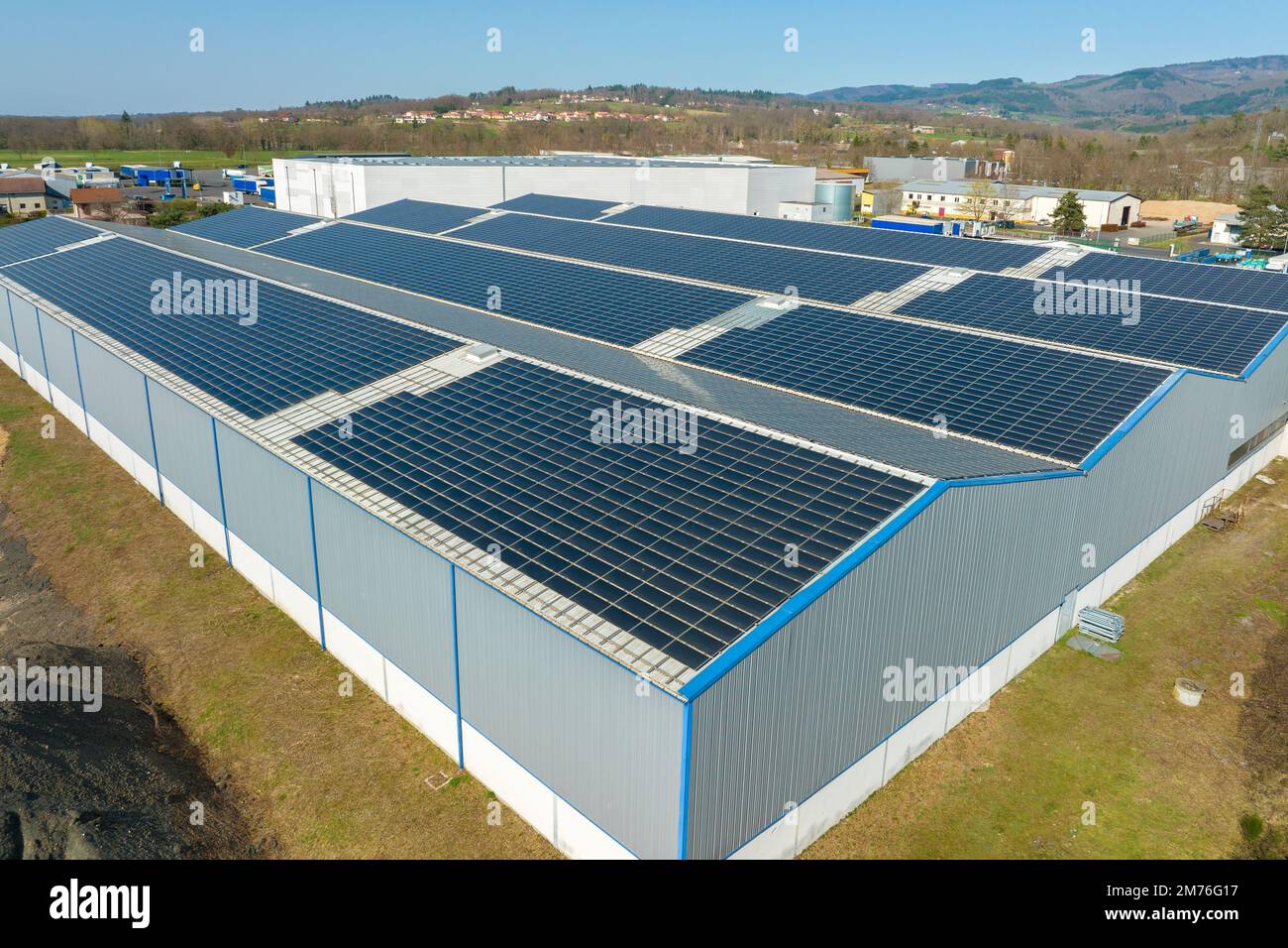 Aerial view of blue photovoltaic solar panels mounted on industrial ...