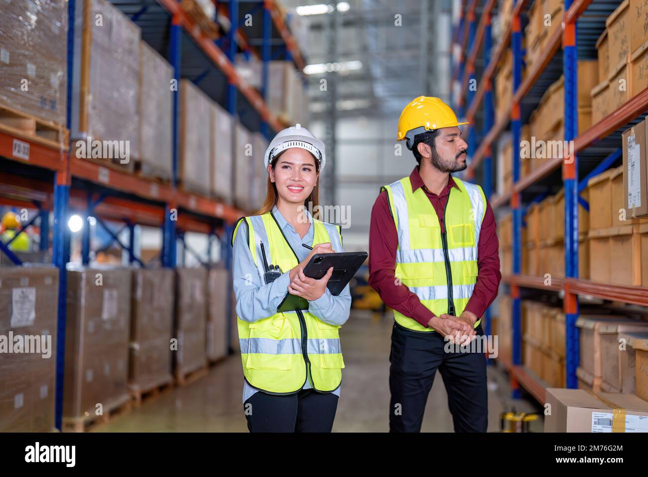 Worker in warehouse hold tablet check list perform inventory stock ...