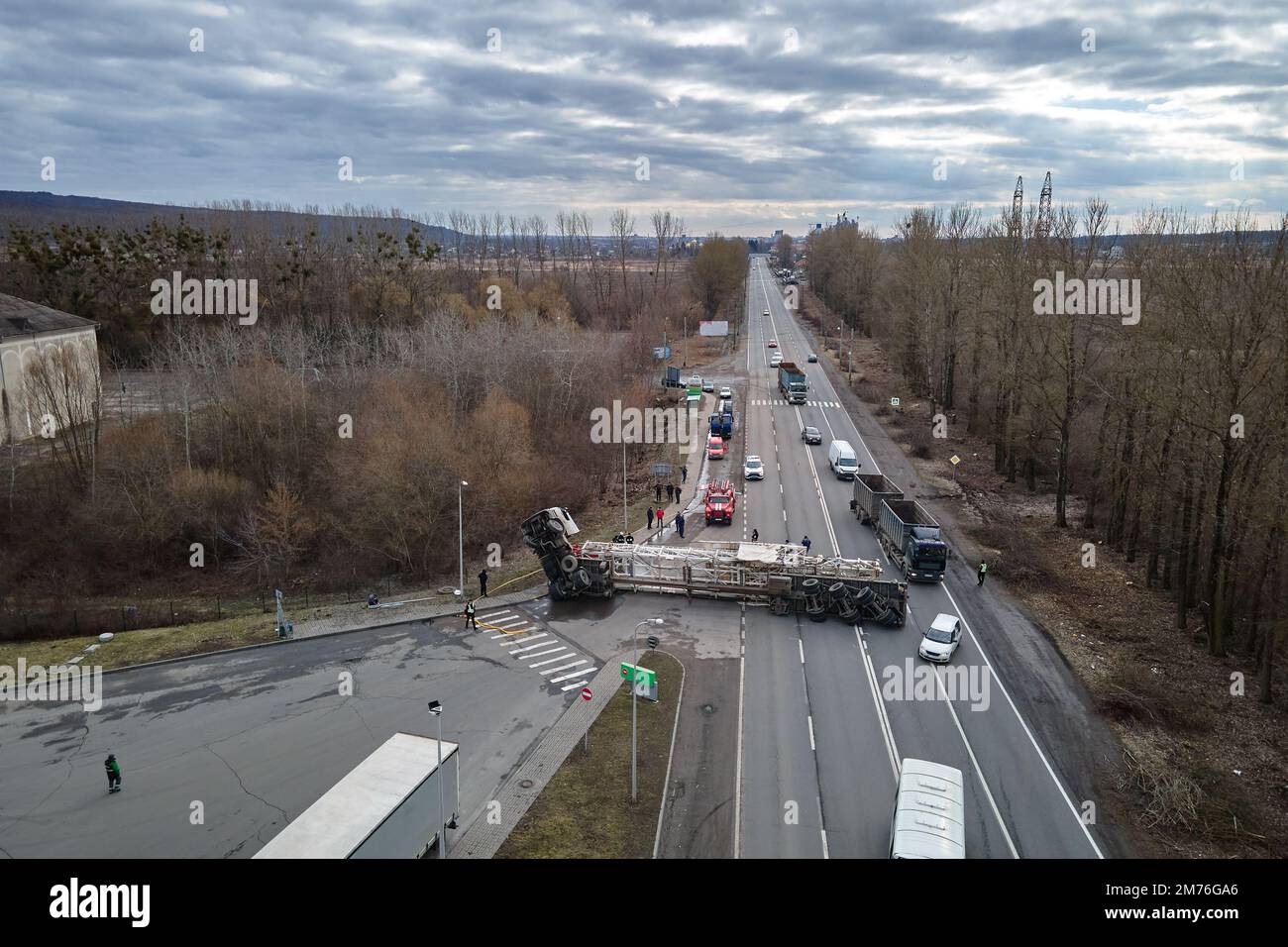 Aerial view of road accident with overturned truck blocking traffic ...