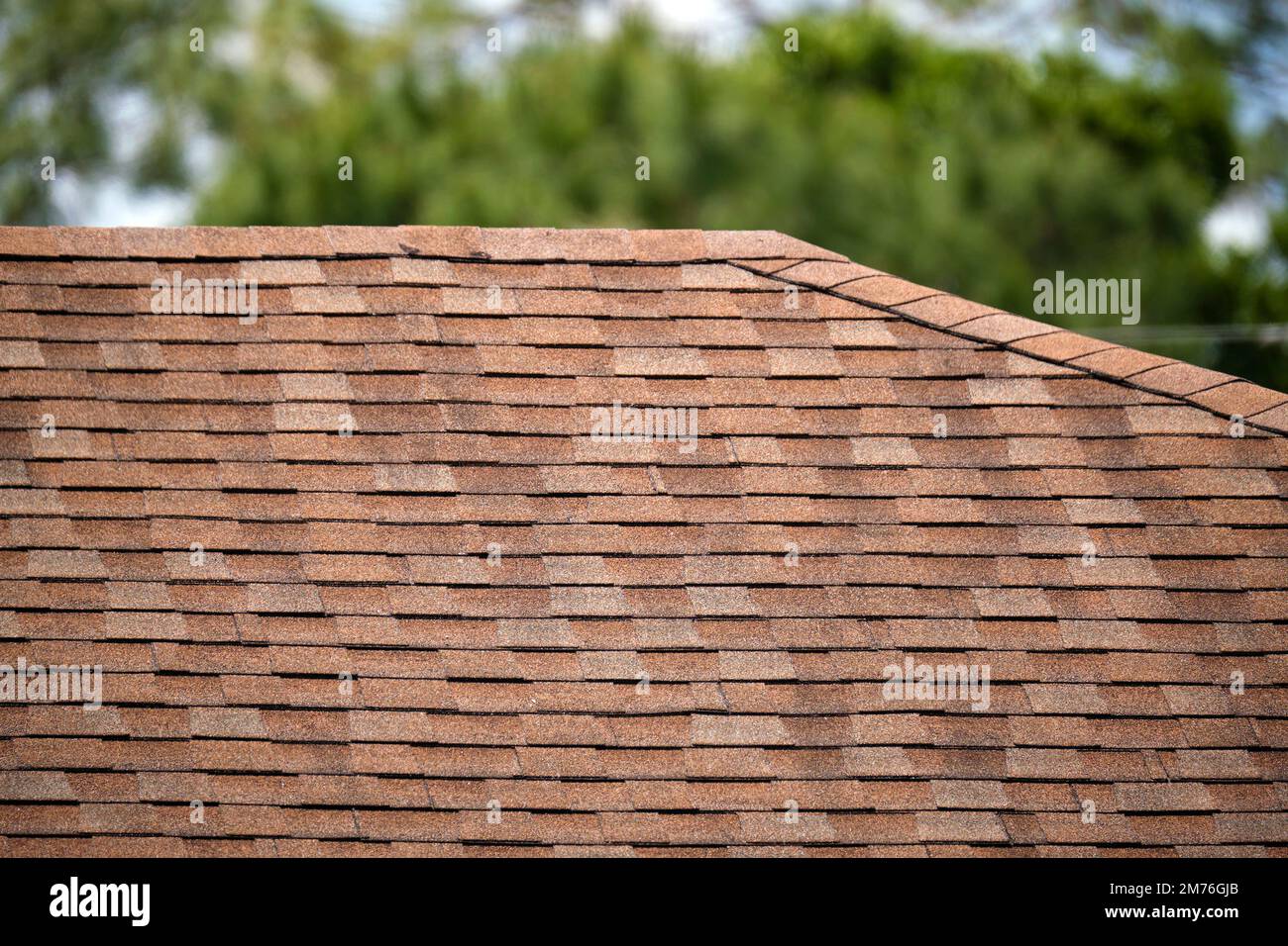 Closeup of house roof top covered with asphalt or bitumen shingles ...