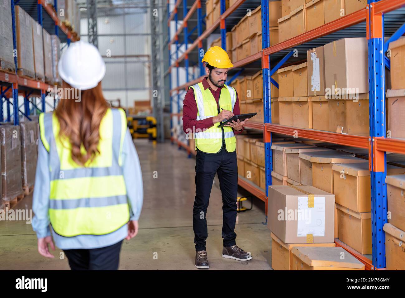 Worker in warehouse hold tablet check list perform inventory stock ...