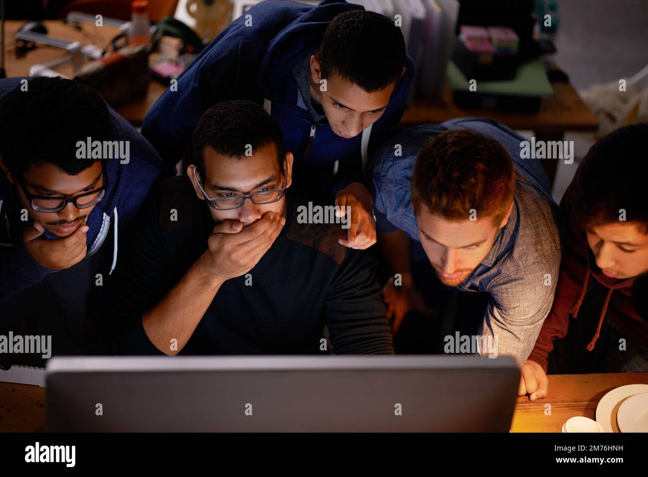 Feeling the loss together. a group of shocked-looking young man staring ...