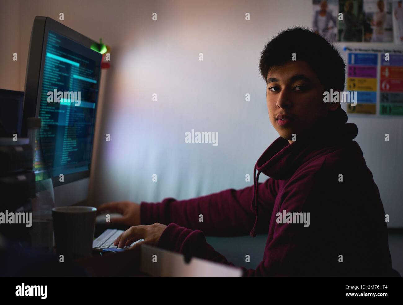 Working on a new game. a young programmer focused on his work Stock ...