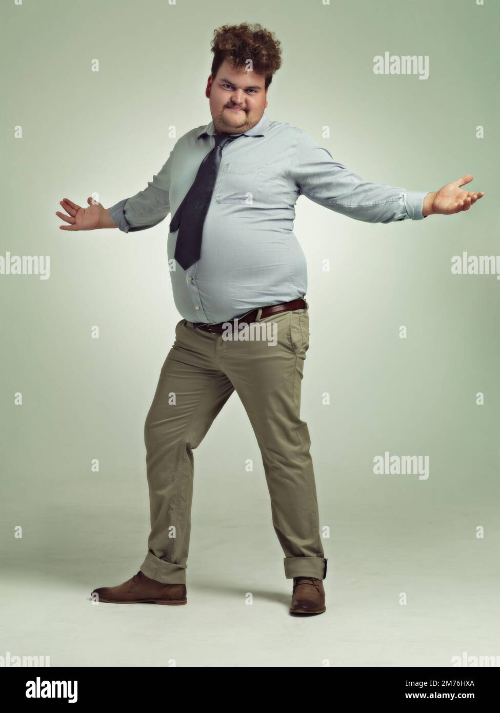Want to dance. Full length shot of an overweight man with his arms ...