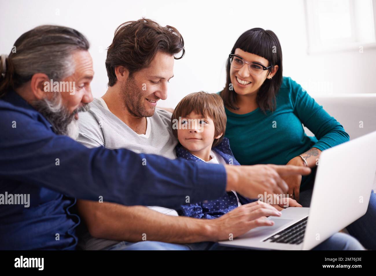 Learning is fun with the family. a family using a laptop together Stock ...