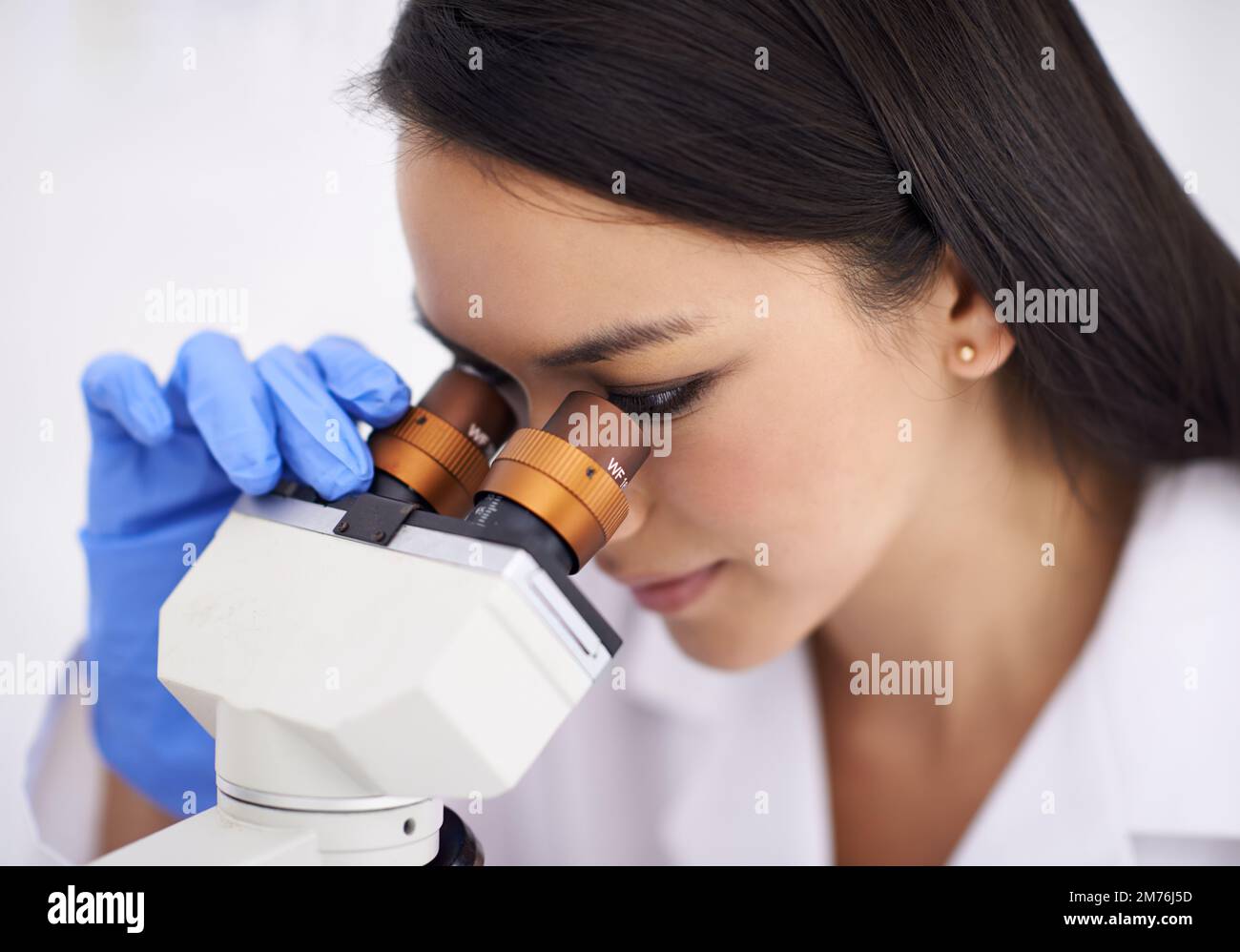 Progress is the result of hard work. Portrait of a female scientist ...
