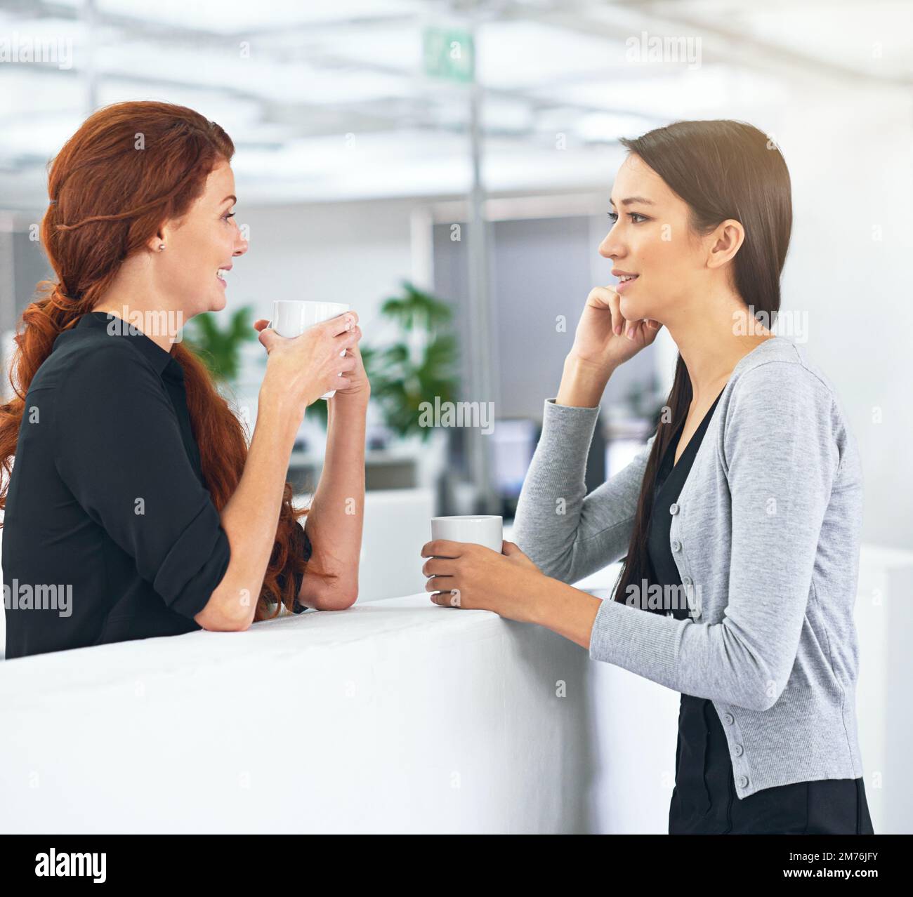 Making friends at the office. two businesswomen having a friendly ...