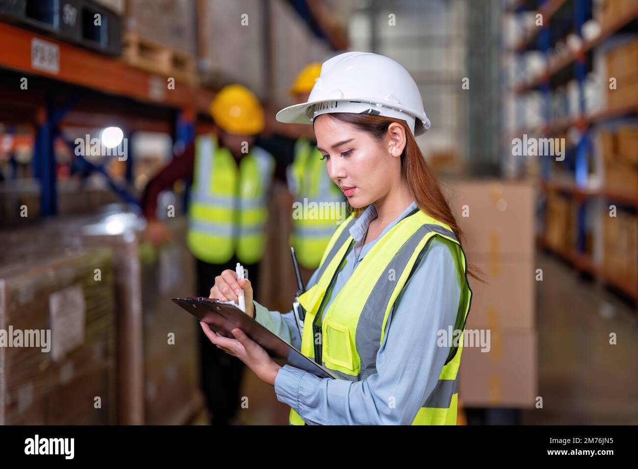 Worker in warehouse hold tablet check list perform inventory stock ...