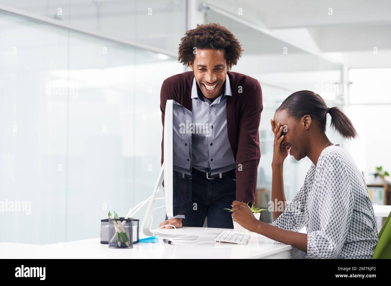 Lighthearted moment with a colleague. two colleagues sharing a laugh in ...