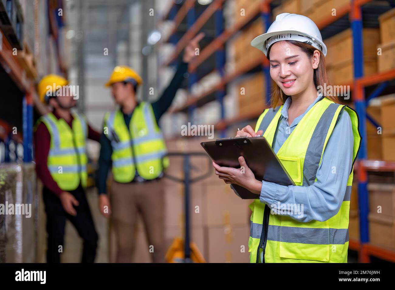 Worker in warehouse hold tablet check list perform inventory stock ...