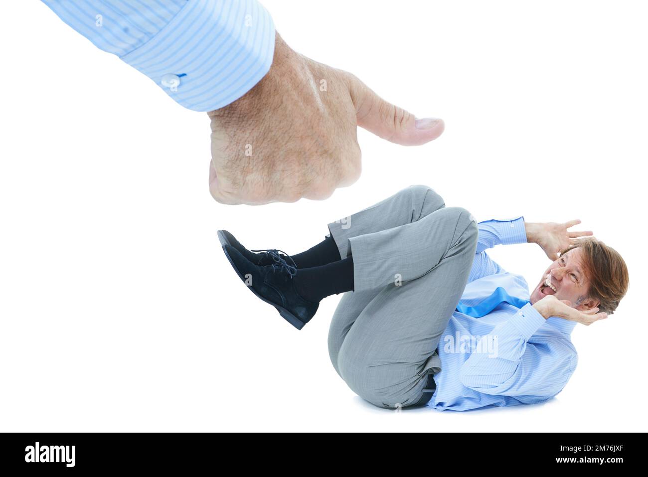 Under the bosss thumb. a businessman lying on the floor protecting ...