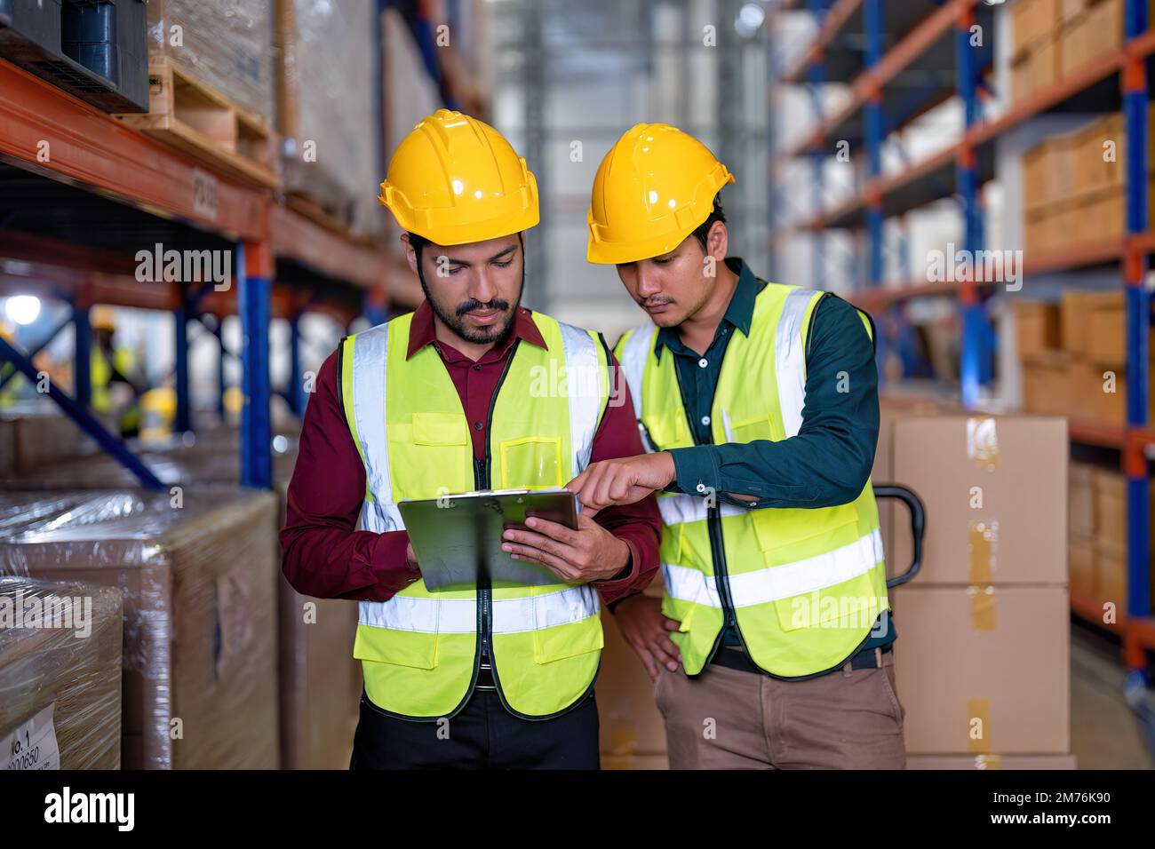 Worker in warehouse hold tablet check list perform inventory stock ...