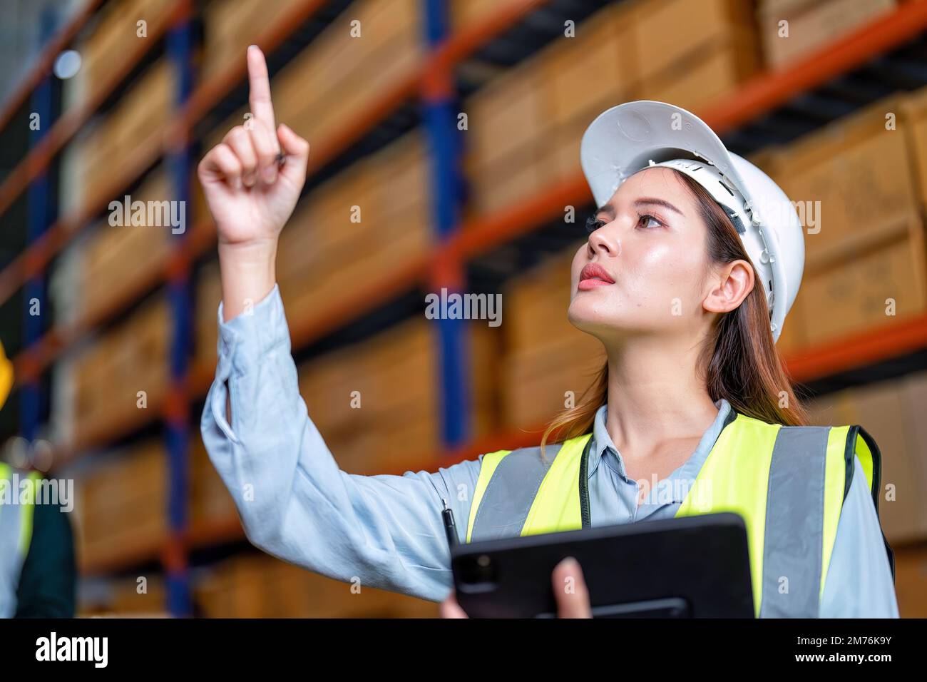 Worker in warehouse holding check list tablet pc stand portrait photo ...