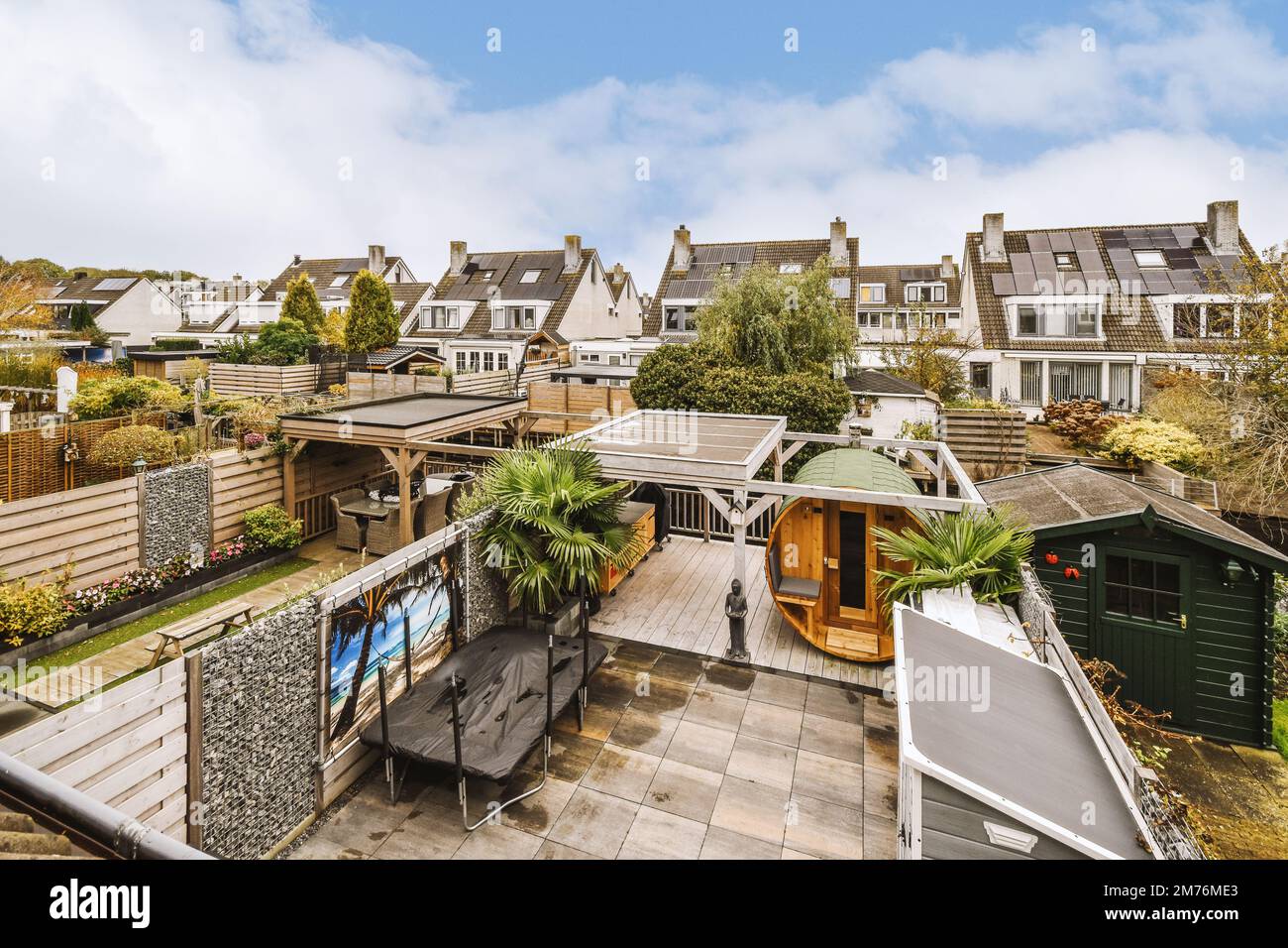 a rooftop with some houses in the background and a sky filled with ...