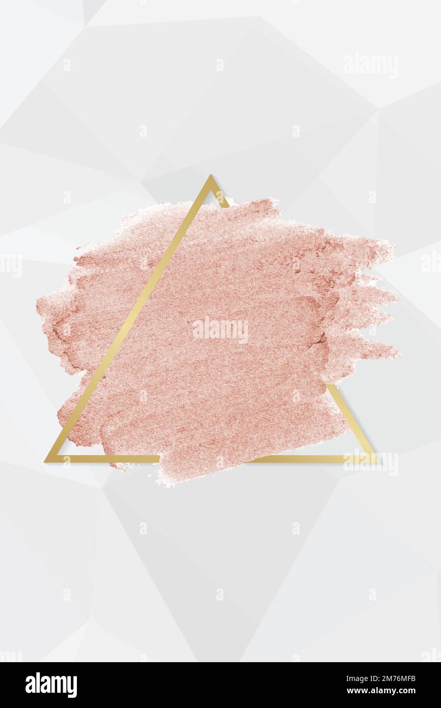 Pastel pink paint with a gold triangle frame on a gray background ...