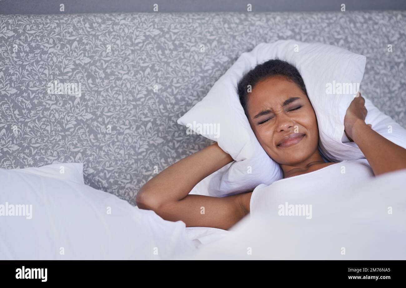 Just five more minutes mom. a restless young woman lying in bed Stock ...