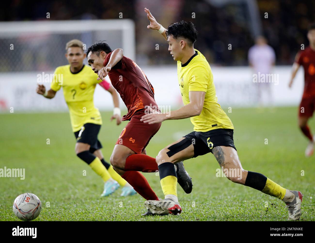 Dominic Tan Jun Jin of Malaysia (R) and Teerasil Dangda of Thailand (C ...