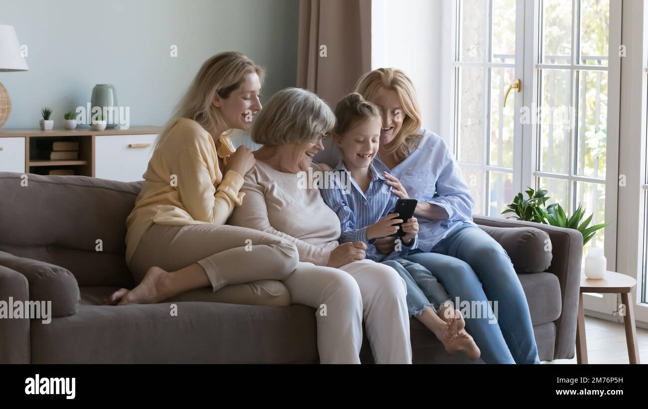 Happy little daughter kid, young mom, middle aged grandma Stock Photo ...