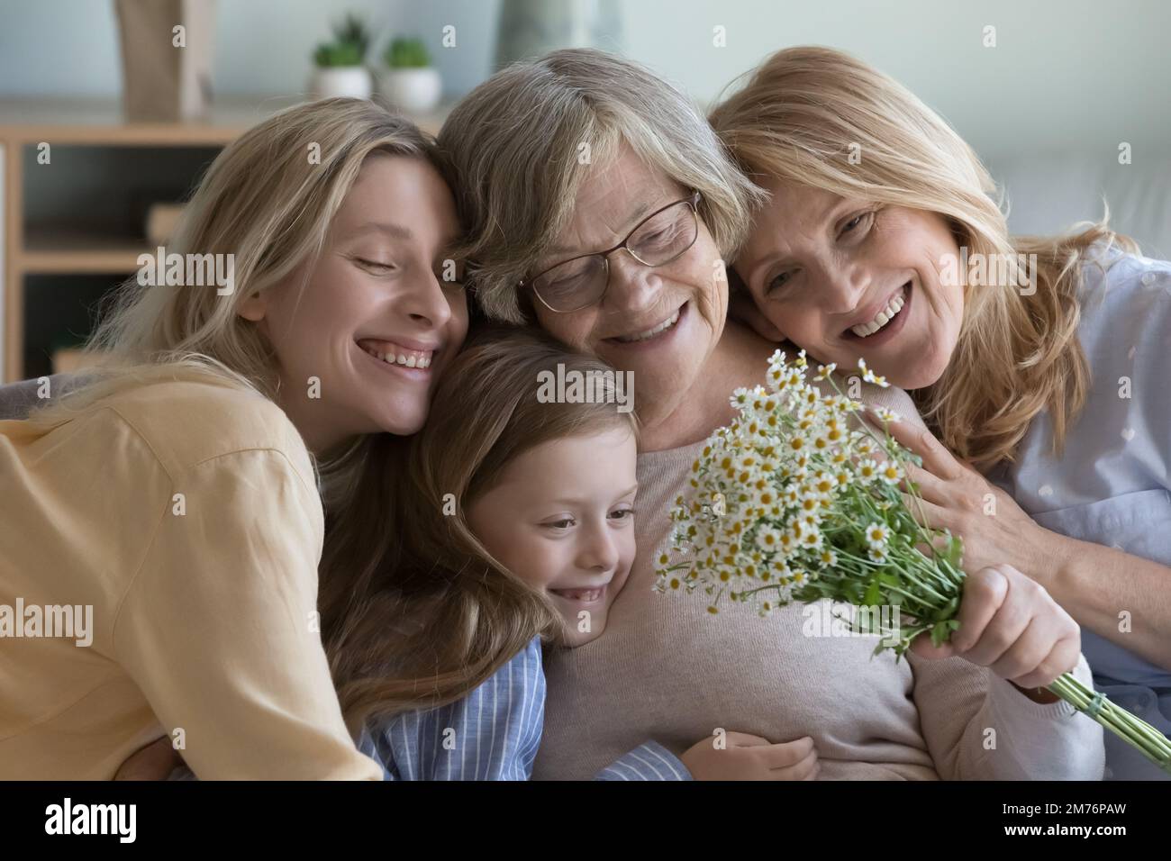 Happy grandkid woman, mature daughter, girl kid hugging elderly grandma ...