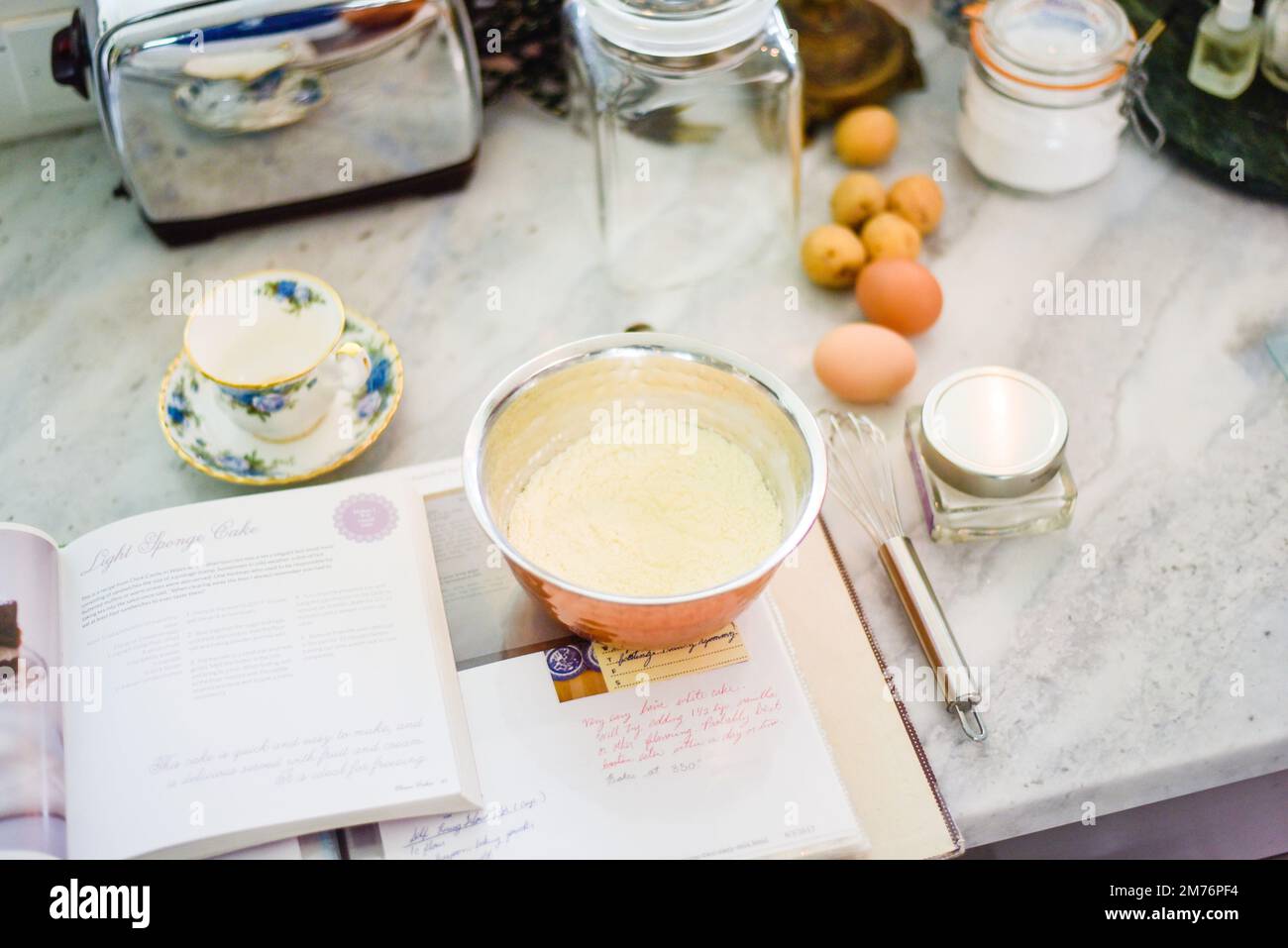 Overhead photo dry baking ingredients arranged on a white marble stone ...