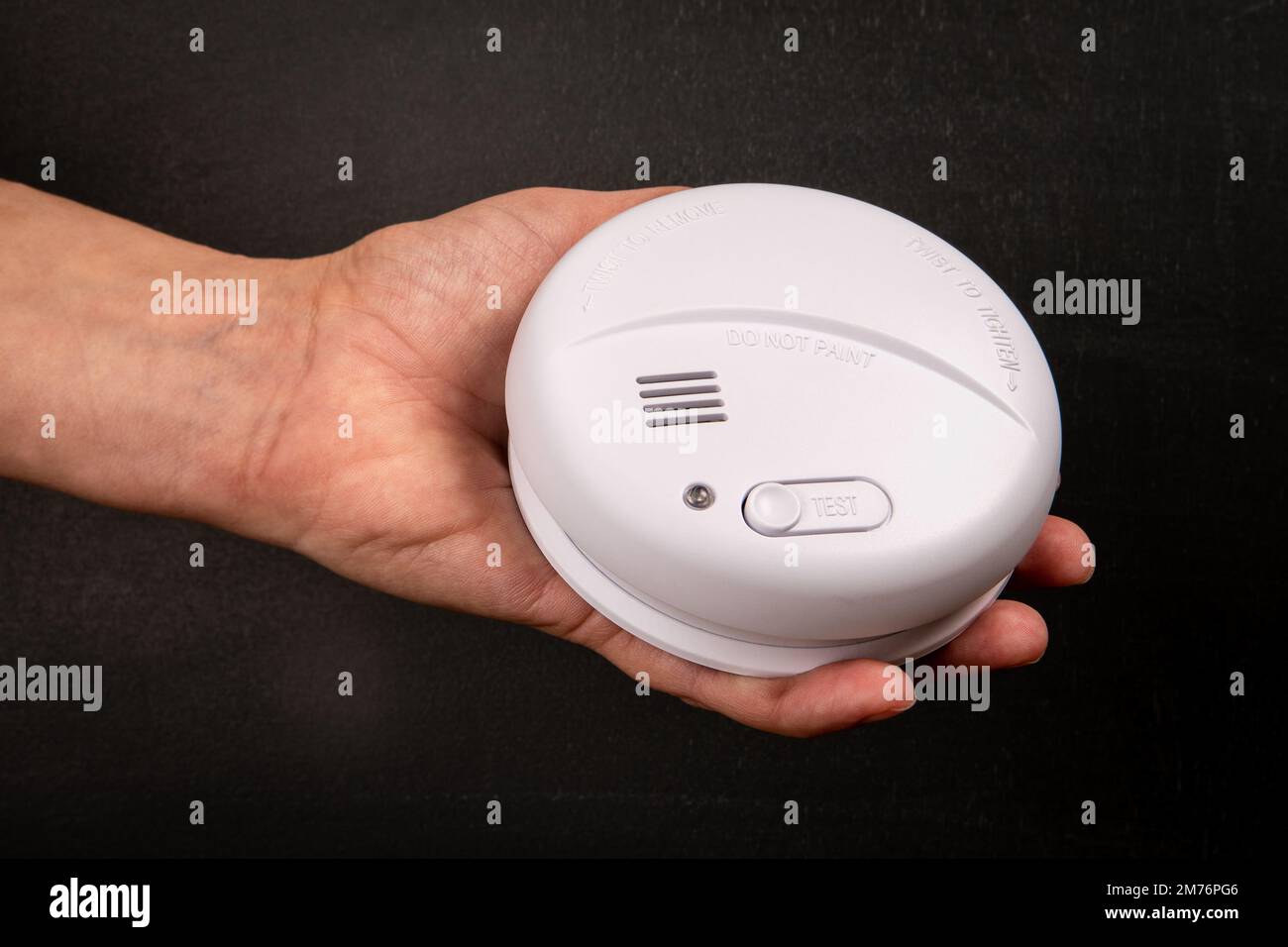 Smoke detector in a woman's hand. Security concept Stock Photo - Alamy