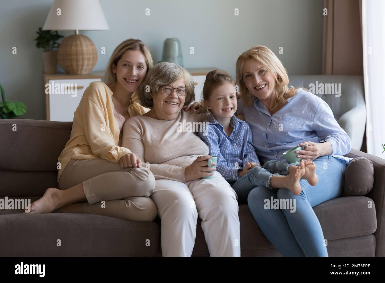 Happy joyful daughter kid, mom. grandma, elderly great grandmother ...
