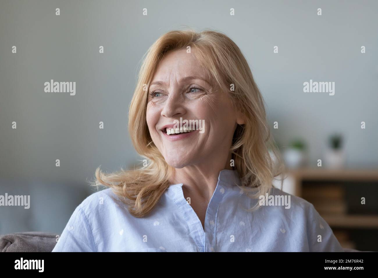 Cheerful attractive mature pensioner woman looking away Stock Photo - Alamy