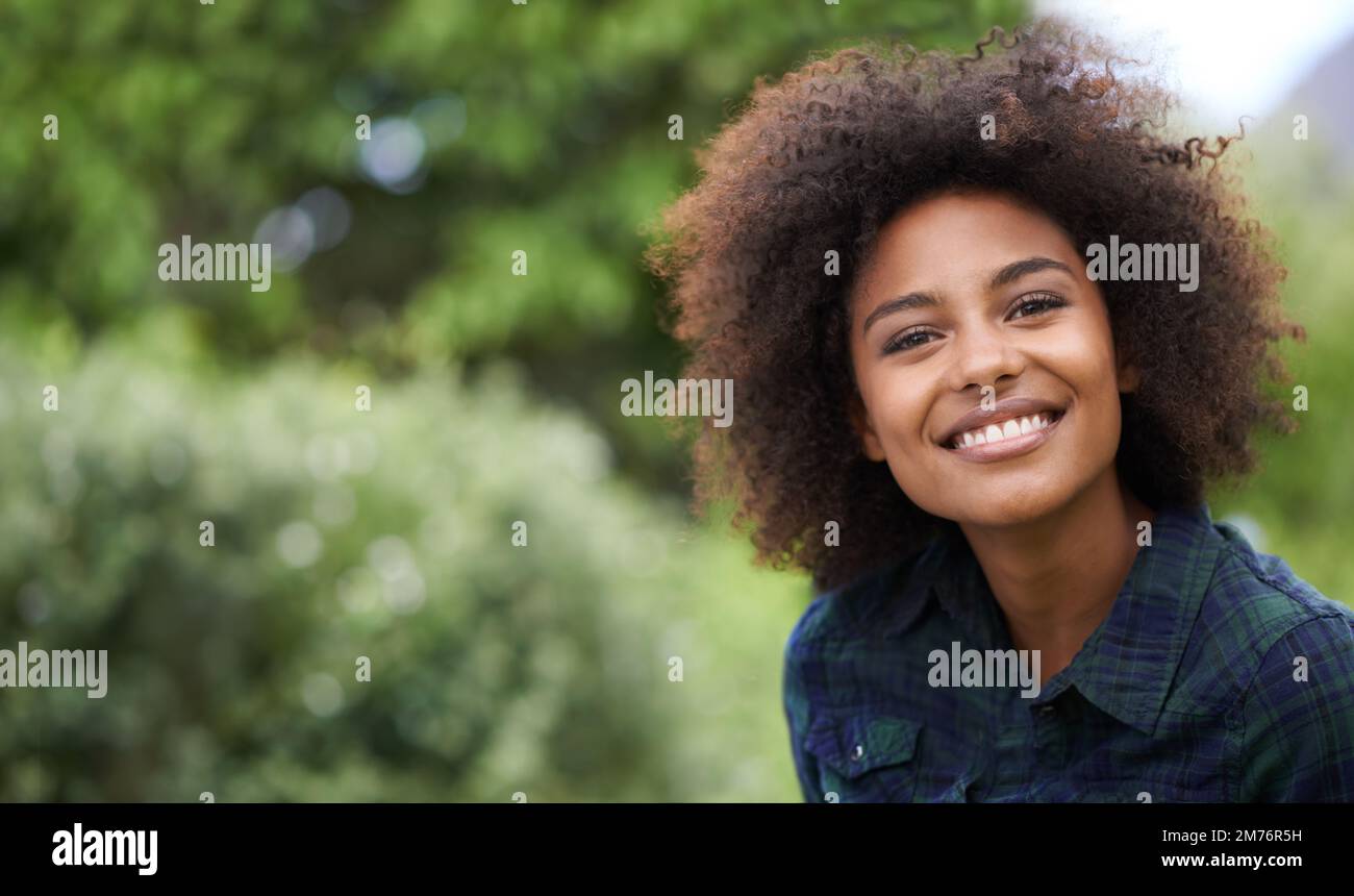 Getting some fresh air. Portrait of a smiling young woman outside in a ...