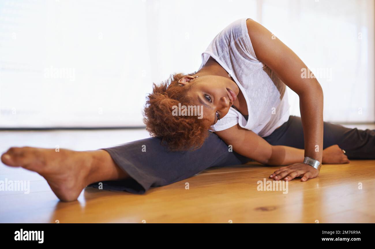 Stretching keeps me at the top of my game. a young woman dancer ...