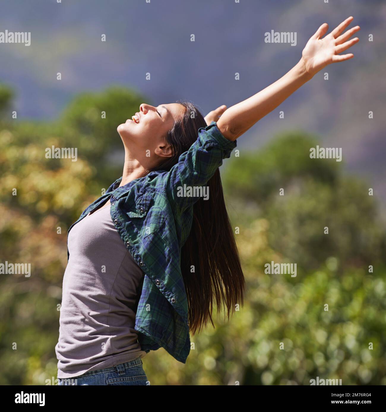 Celebrating the sun. Portrait of an attractive young woman celebrating ...