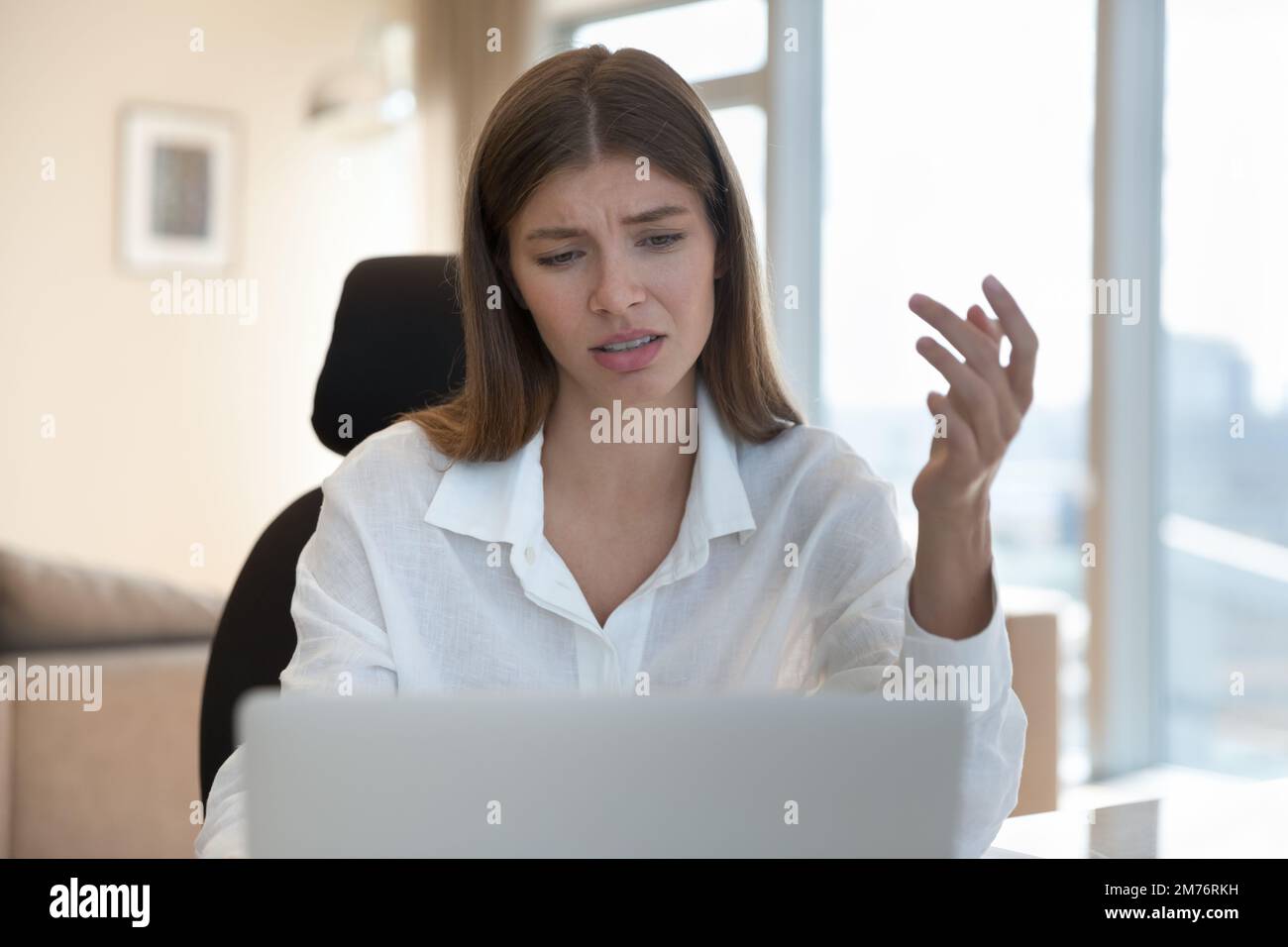 Woman read bad news on laptop looks disillusioned and upset Stock Photo ...