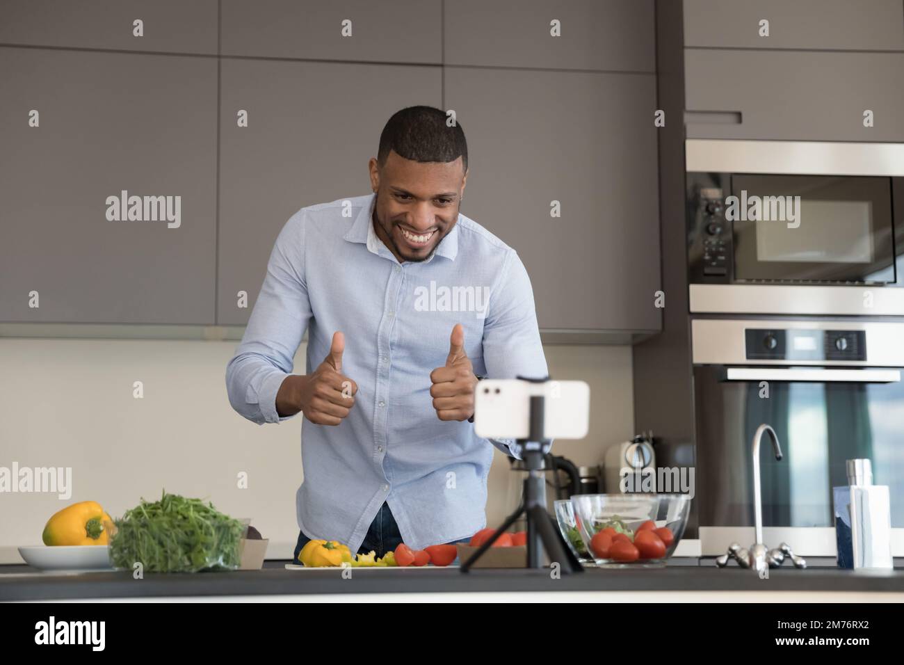 African food blogger shooting vlog for social media on smartphone Stock ...