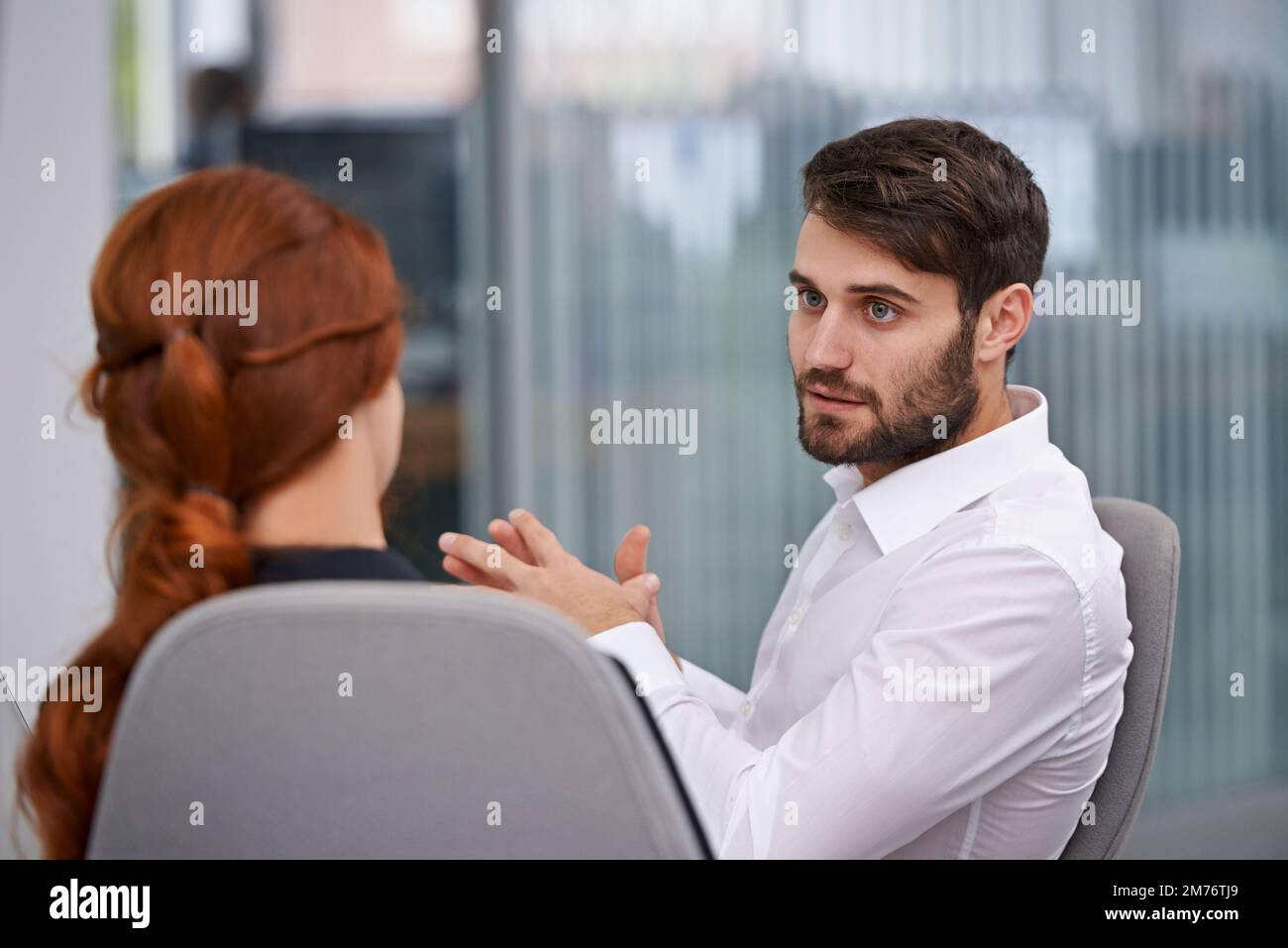 Discussing new business strategies. Two work colleagues having a ...