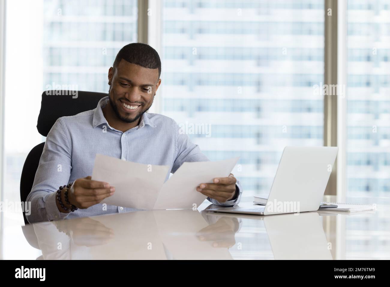 African business man read document paper report smile feels satisfied ...