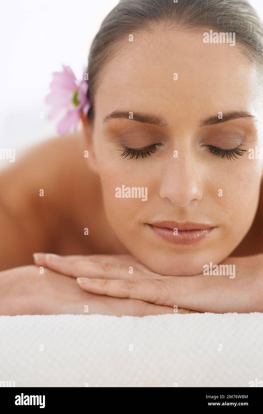 This is the life. Closeup of a beautiful young woman with a flower in ...