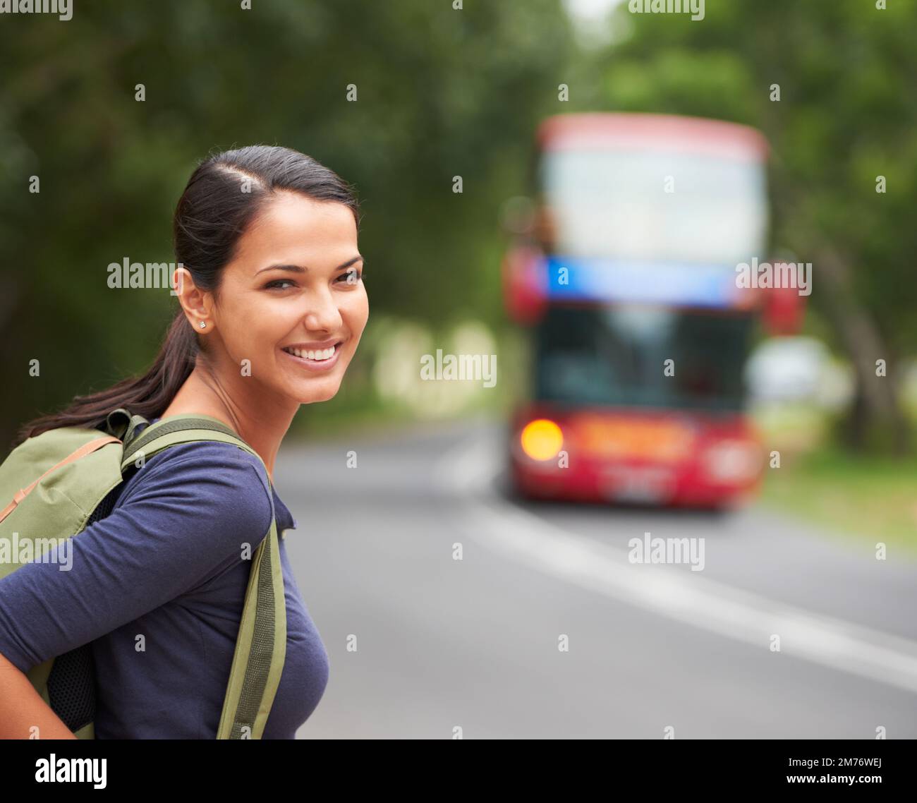 Can you give me a ride. A beautiful young woman wearing a backpack ...