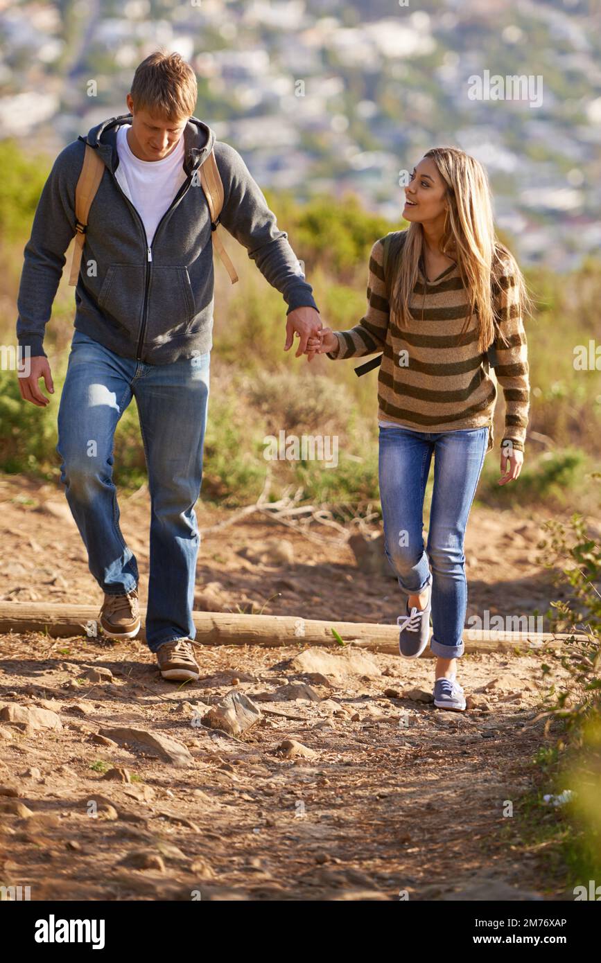 Making their way together. a happy young couple holding hands while out ...