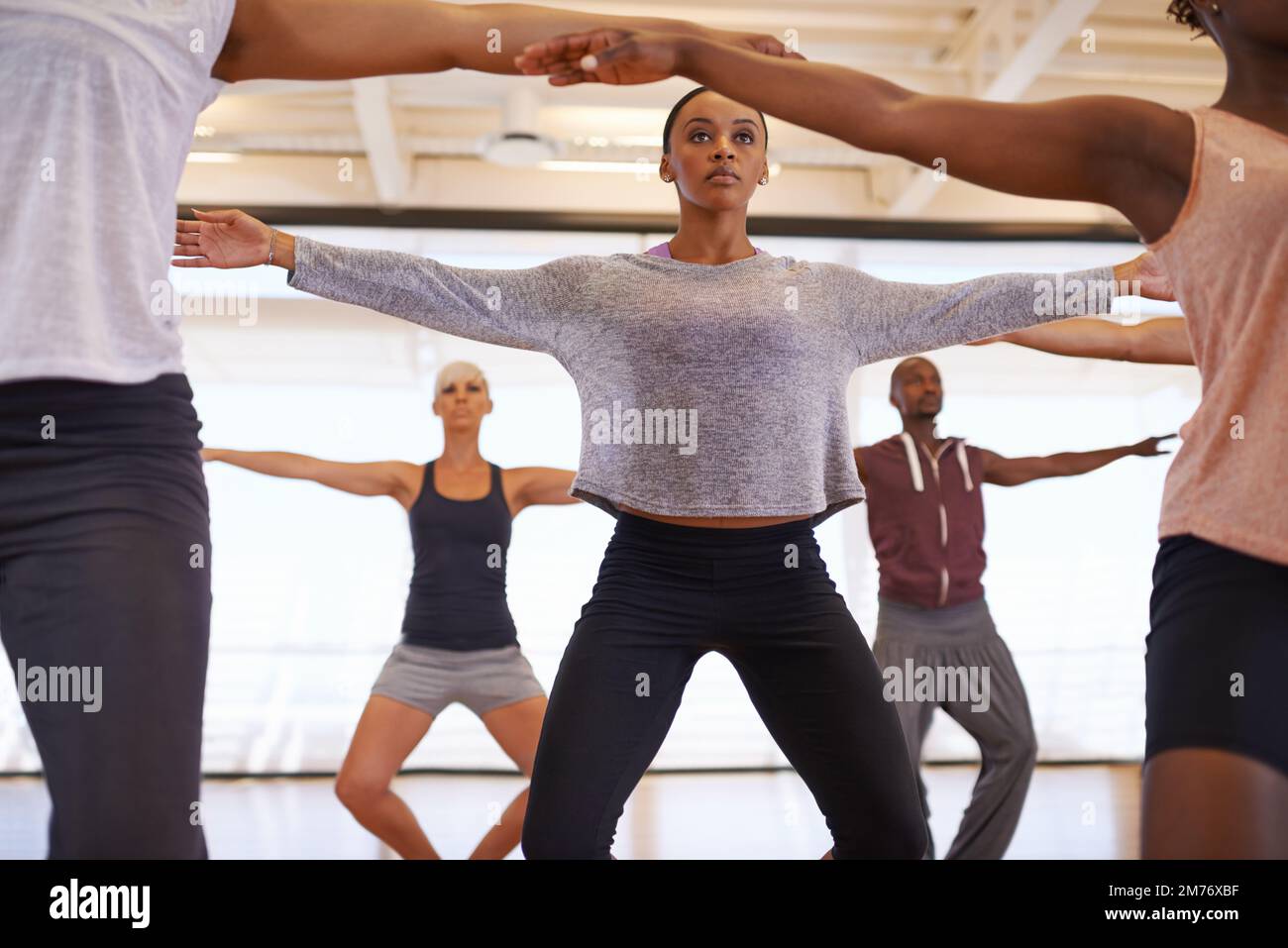 Keeping the body well aligned. a group of young dancers stretching ...