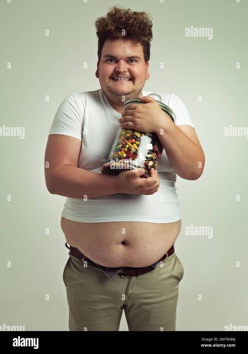 All mine. an overweight man smiling happily while holding a jar of ...