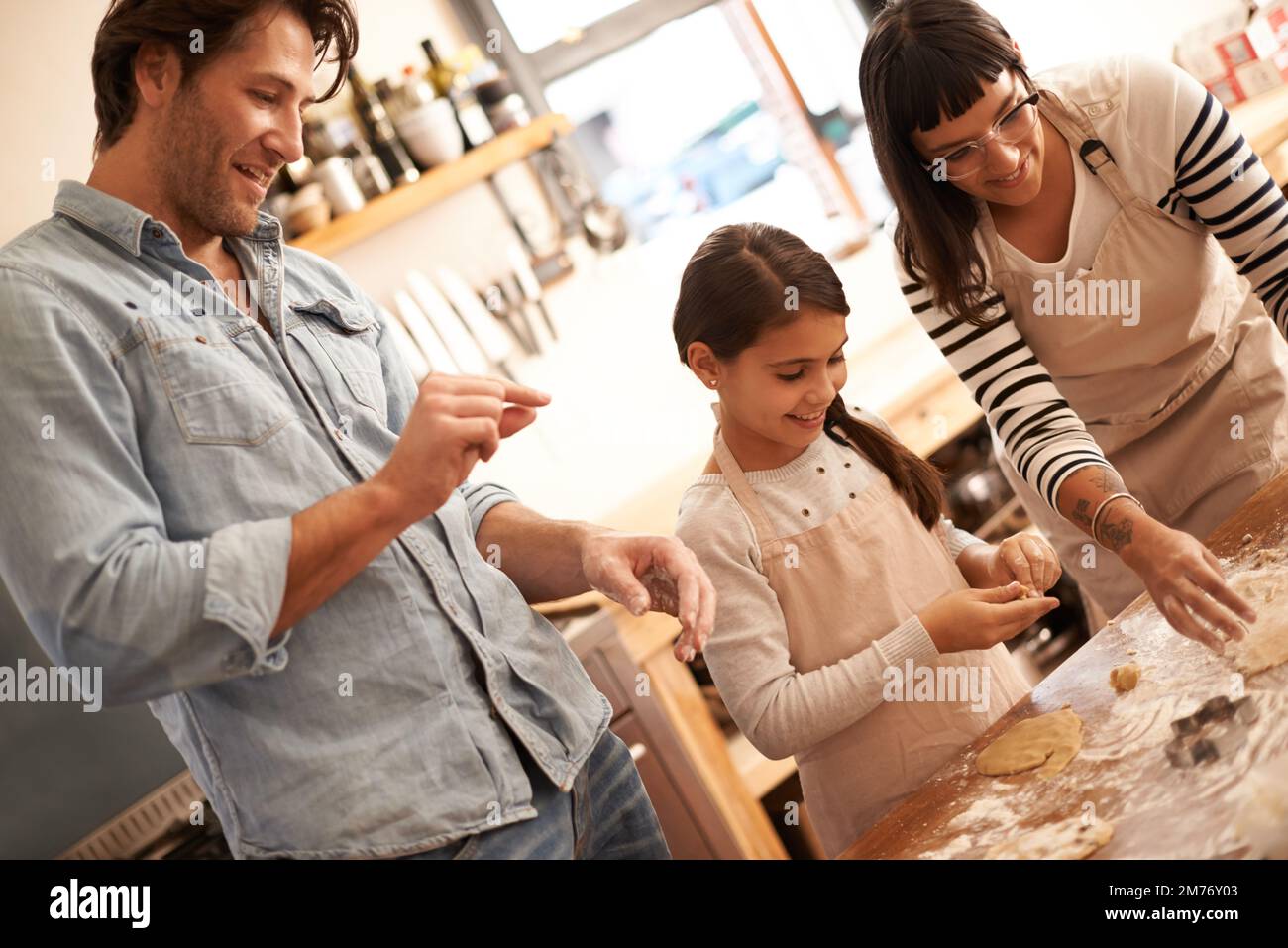 Playing with the dough. a family having fun baking in a kitchen Stock ...