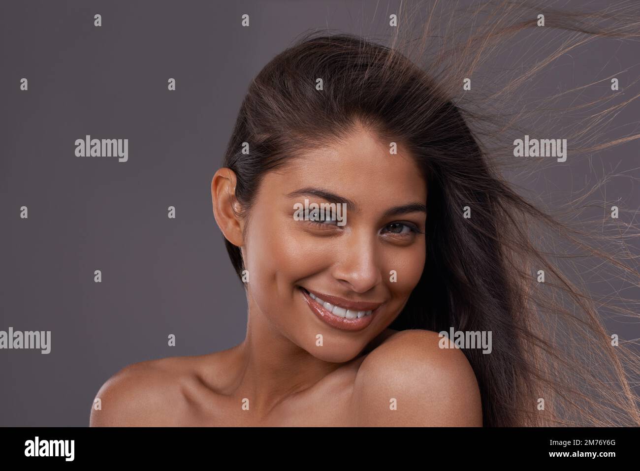 Giving you a knowing smile. Portrait of an attractive young woman with ... Giving you a knowing smile. Portrait of an attractive young woman with ...