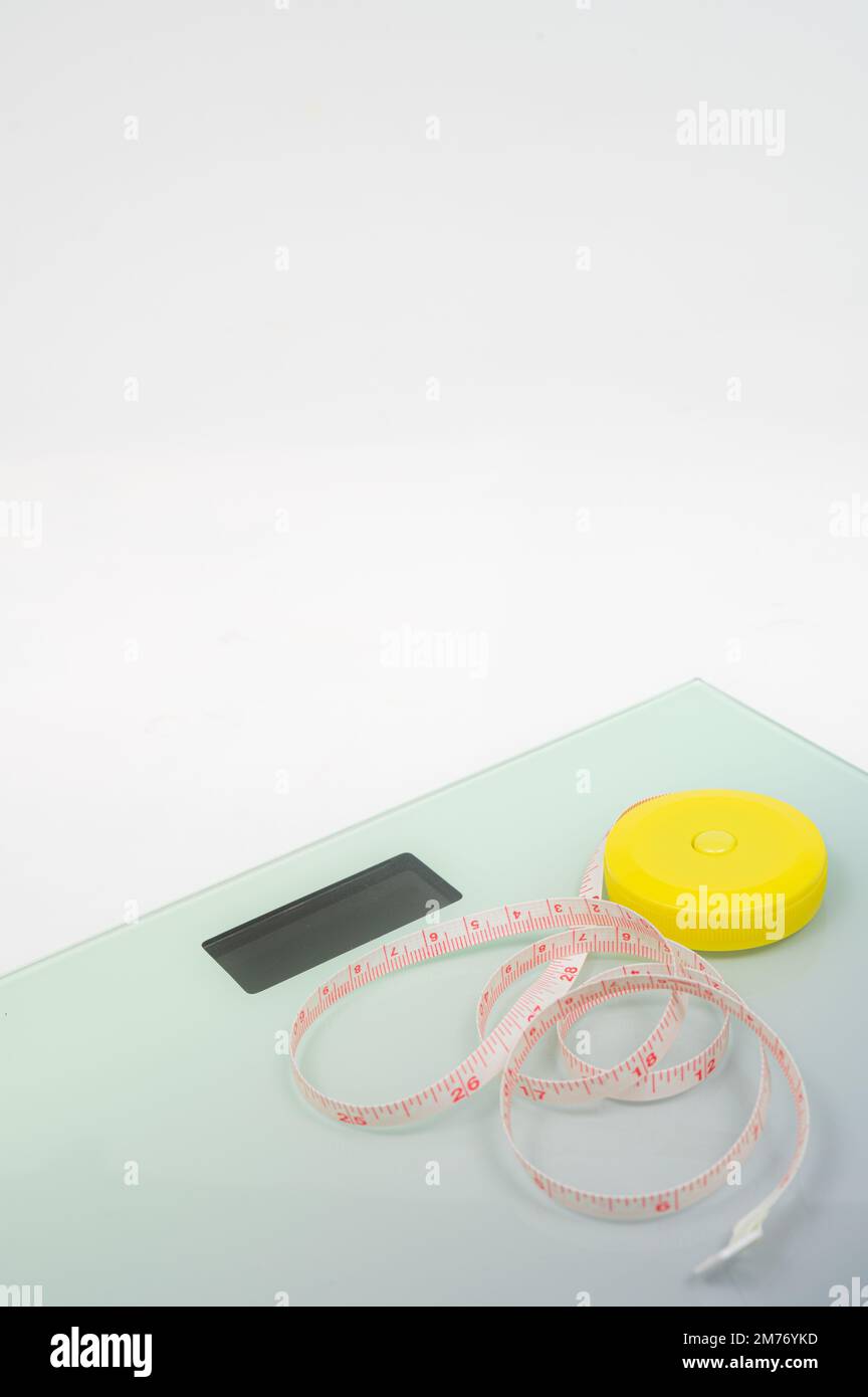 Weight scale and tape measure isolated on white background with copy ...