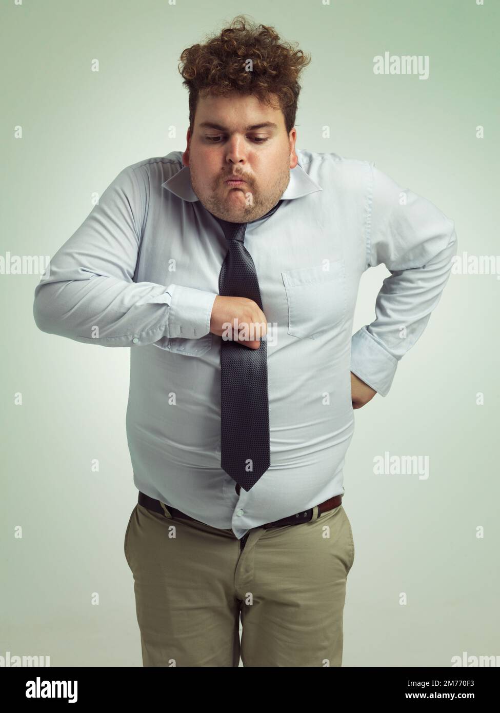 Dinner is about to make a repeat performance. an overweight man holding ...